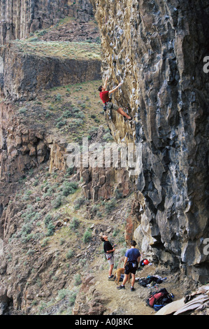 Three young men on a rock Stock Photo - Alamy