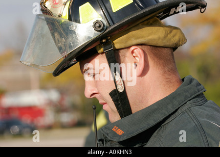 Firefighter on the radio listening to a fire scene chatter Stock Photo ...