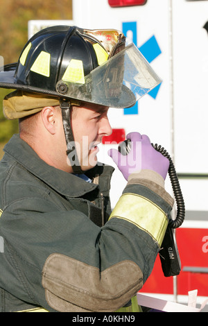 Firefighter on the radio listening to a fire scene chatter Stock Photo ...