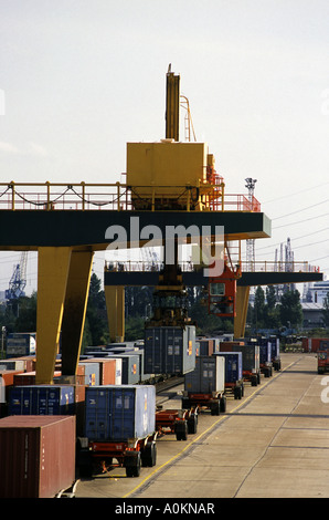 Container crane lifting portainer shipping container from cargo ship ...