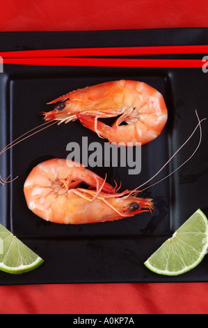 two Queensland banana prawns on a black plate dsc 9953 Stock Photo - Alamy