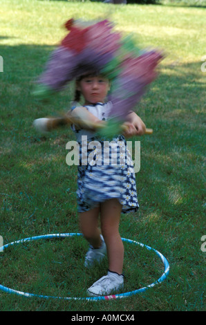 1 one young girl swings at party pinata Stock Photo - Alamy
