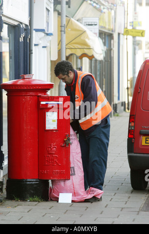 A Royal Mail worker emptying his van Stock Photo - Alamy