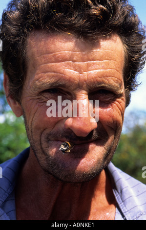 Juruena Amazon Brazil Man with an unshaven weatherbeaten face smoking a ...