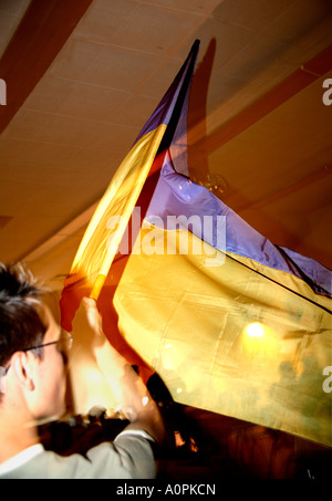 Ukrainians hold Ukrainian and European flag as the Eiffel Tower is ...