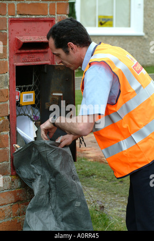 Royal Mail postman collecting letters street red postbox van talking ...