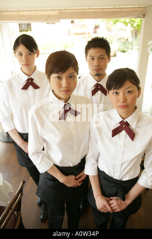 Portrait of three waitresses and a waiter Stock Photo - Alamy