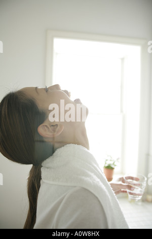 Woman rinsing mouth with mouthwash on white background. Oral hygiene ...