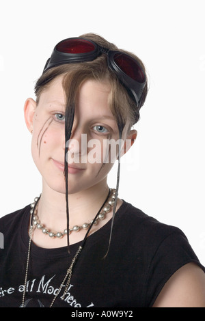 Goth teen girl in black clothes holding favorite boo in hands while ...