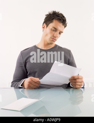 Young man reading letter at table in cafe. Mail delivery Stock Photo ...