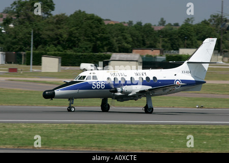 Royal Navy Jetstream T2 lands on airfield runway in front of hangars ...