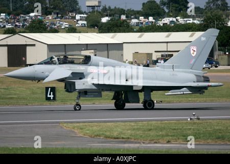 RAF Eurofighter Typhoon landing on runway 25 at RAF Coningsby out of a clear blue sky. Aircraft ...