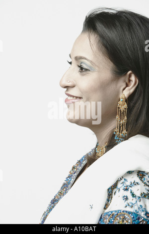 A side-view shot of a mid-adult businessman standing on a train ...