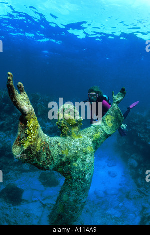 A FEMALE SCUBA DIVER AT THE STATUE OF CHRIST OF THE ABYSS IN KEY LARGO ...
