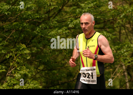 Triathlete running at Bala Middle Distance Triathlon Stock Photo - Alamy