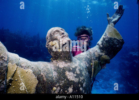 A FEMALE SCUBA DIVER AT THE STATUE OF CHRIST OF THE ABYSS IN KEY LARGO ...