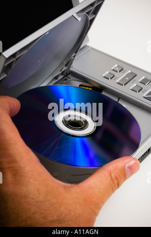 Man putting DVD into player Stock Photo - Alamy