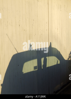 Shadow of a car reflected on a wall painted with a colorful graffitti ...