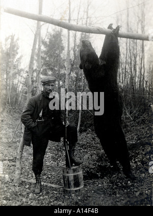 Bear Hunter With Dead Bear Stock Photo - Alamy