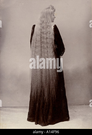 Woman with long hair back view on blue background Stock Photo - Alamy