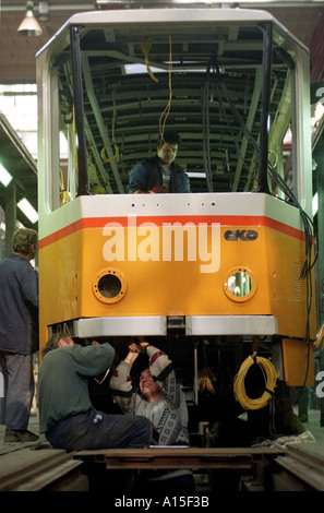 Workers prepare a tram at the CKD tram and train factory in Prague ...