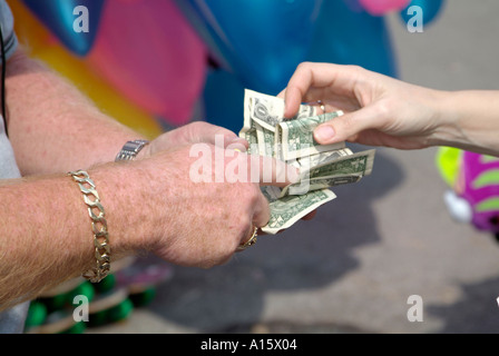 Cash money changing hands between a buyer and seller Stock Photo - Alamy