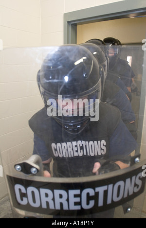 Cell extraction Officers entering cell to control unruly inmate in ...