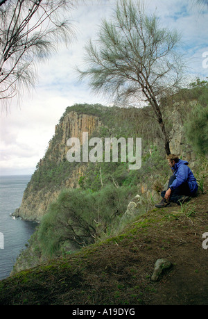 Walker sat at top of huge cliffs at Fluted Cape near Adventure Bay ...