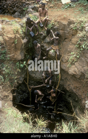 Boran people raising water in giraffe hide buckets at the Singing Wells ...