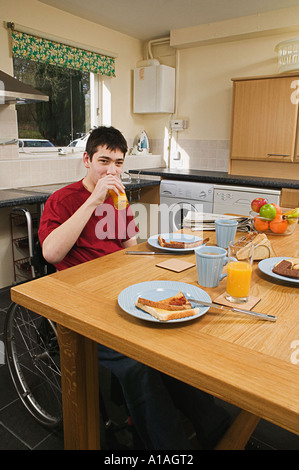 a smiling disabled having breakfast Stock Photo - Alamy