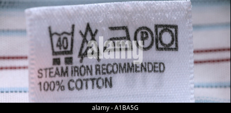 Washing instructions clothes tag label over pastel color cotton fabric ...