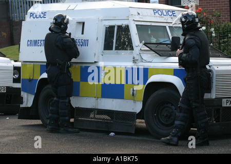 Police PSNI riot squad members in discussion at landrover before parade ...