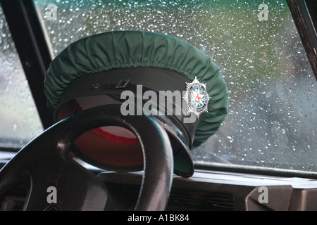 Police PSNI peaked cap with badge insignia on landrover dashboard in ...