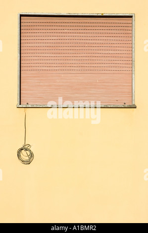 coiled electrical cable hanging from a window Stock Photo - Alamy