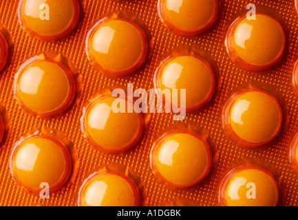 Closeup of orange package of pills tablets drug medicine as background ...