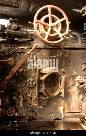 Detailed view of an old rusty steam train's wheel assembly in an ...