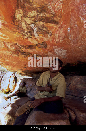 Indigenous Australian Aborigines in a cave around a bonfire. Queensland ...