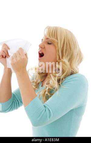 Allergic young woman with tissue and eye drops in park on spring day ...