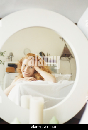 Redhead woman at home smiling looking to the camera showing fingers ...
