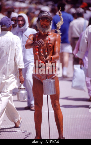 A sadhu pierces his arm with a carving knife Sadhus are ascetics whose ...