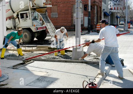 Heavy equipment and manual labor us used in road repair and new street ...