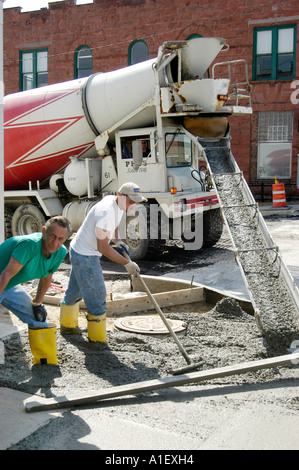 Heavy equipment and manual labor us used in road repair and new street ...