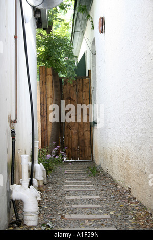 Back alley with fire escape and old mattresses Stock Photo - Alamy