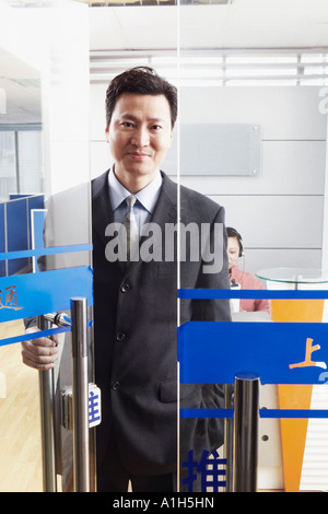 Portrait of two happy businessmen wearing party hats in a factory Stock ...