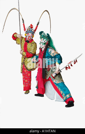 Two male Chinese opera performers gesturing with weapons Stock Photo ...