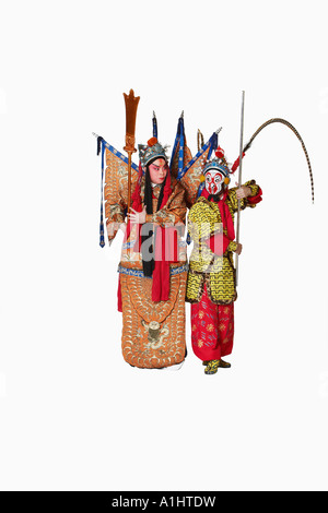 Two male Chinese opera performers gesturing with weapons Stock Photo ...