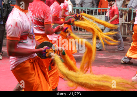 Devotees dance during a procession for immersion of Durga idols as part ...