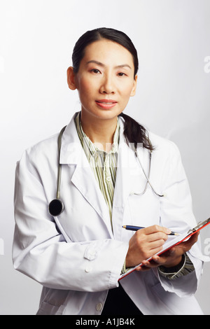 Asian women doctor holding clipboard medical record smiling ...