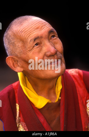 A vertical shot of an Adult Tibetan Buddhist worshiper with a ritual ...
