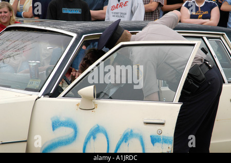Prom Drunk Driving Demo Police officer helps backseat passenger from ...
